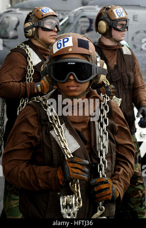U.S. Navy plane captains watch flight operations from the flight deck ...