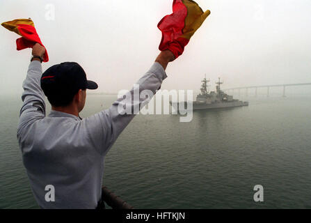 US Navy A Signalman uses semaphore to communicate via hand signals with ...