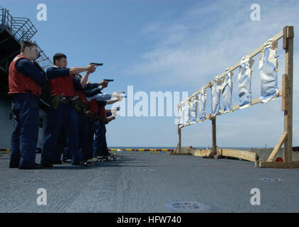 US Navy Personnel take aim at their targets during a live-fire 9mm ...