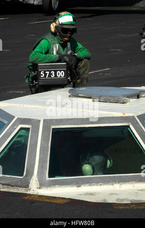 US Navy A Catapult Weight Board Operator relays the weight of an F-A ...