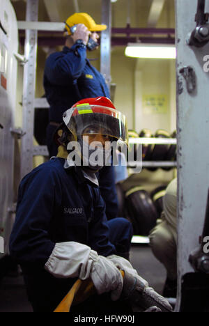 US Navy Repair locker personnel are instructed how to properly move a ...