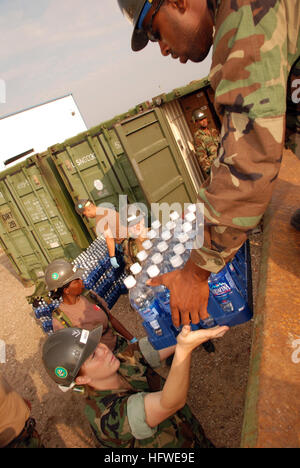 Members of the US Navy Amphibious Construction Battalion 2, off-load a ...