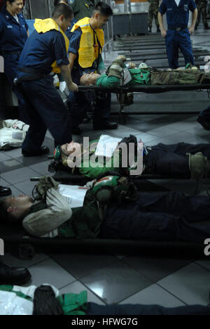 US Navy Simulated personnel casualties lie in stretchers at a medical ...