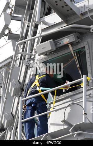 US Navy Quartermaster Seaman cleans the viewing ports during a vertical ...