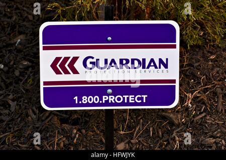 A Guardian protection sign displayed in the front of a residential home ...