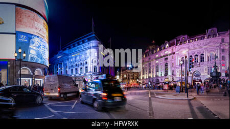 Piccadilly Circus at evening time with the iconic advertising screen ...