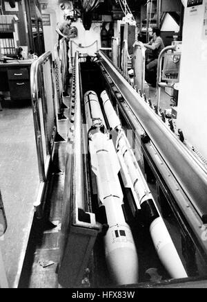 An SM-2 (ER) missile is loaded on the missile house rail aboard the ...