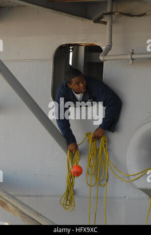 US Navy A Sailor pulls a line aboard the Nimitz-class aircraft carrier ...