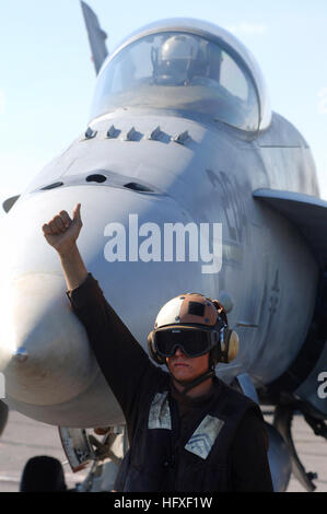 US Navy A Plane Captain stands by on the flight deck aboard the Nimitz ...