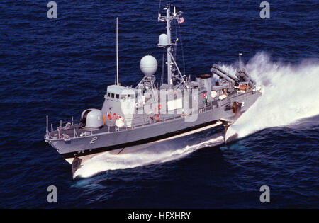A patrol combatant missile hydrofoil (PHM) raises a wall of water as it ...