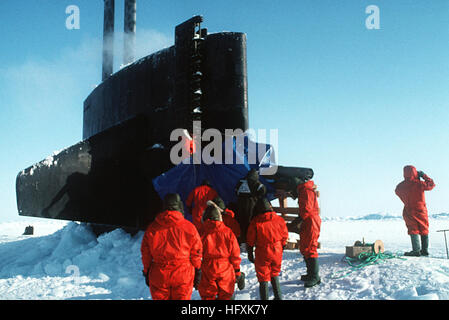 Crew members gather near the sail of the nuclear-powered attack ...