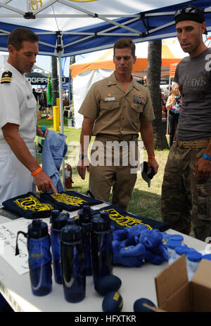 U.S. Navy Cmdr. David Haas uses a rowing machine to work the same ...