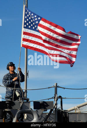 A sailor on the fantail of the guided missile frigate USS HALYBURTON ...
