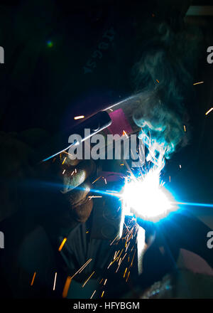 US Navy Hull Technician uses a grinder in he ships Stock Photo - Alamy