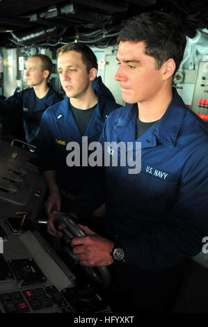US Navy A helmsman steers USS John C. Stennis (CVN 74) on course from ...