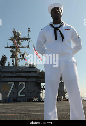 A US Navy sailor stands at parade rest during a uniform inspection ...