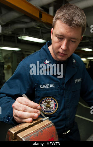 US Navy Machinery Repairman 3rd Class measures hole depths for a job in ...