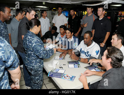 US Navy Members of the Everett Aquasox baseball team sign autographs on ...