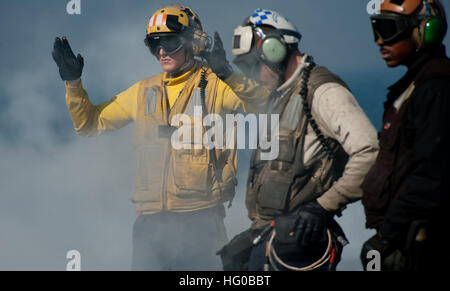 An Aviation Boatswain's Mate directs fixed-wing aircraft on USS John C ...