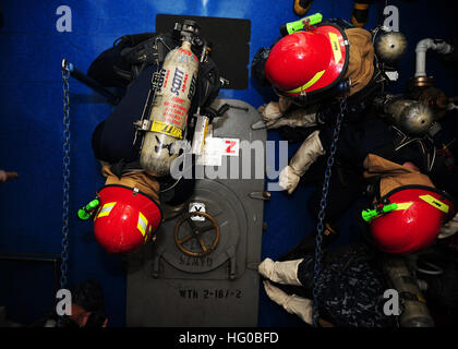 US Navy Sailors secure a watertight hatch during a general quarters ...