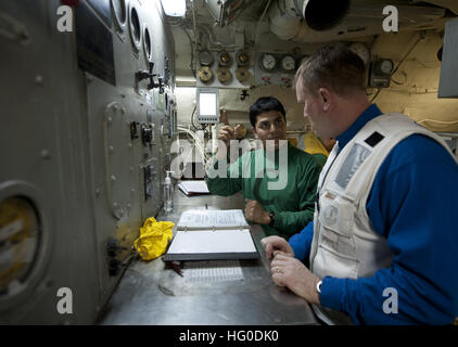 US Navy A Sailor discusses catapult operations with Rear Adm. Thomas K ...