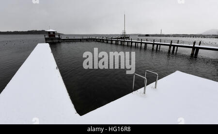 Prien, Germany. 4th Jan, 2017. Snow lies on a jetty at Chiemsee lake ...