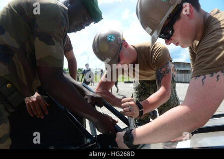 Military members from the Gabonese Armed Forces stand in formation ...
