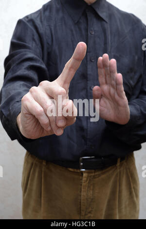 A man saying stop or no with a finger gesture. Refusing to take the ...
