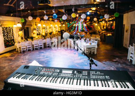 Microphone and synthesizer on concert stage with defused bokeh lights ...