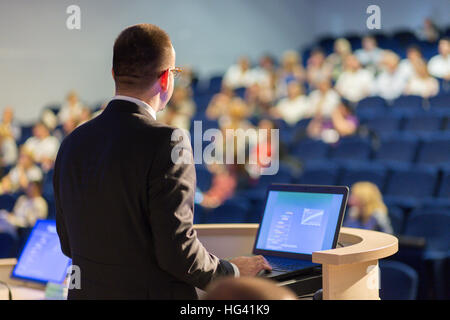 Businessman speaker giving talk on corporate business meeting in ...