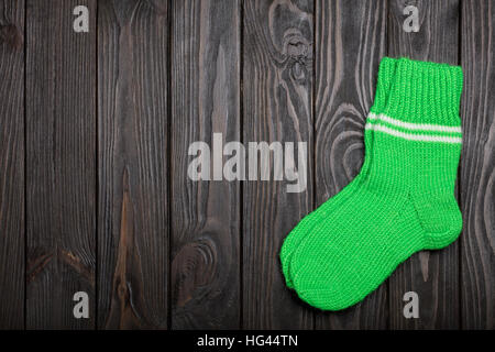 Knit green wool socks on wooden background light Stock Photo - Alamy