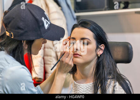 Unrecognized woman cosmetologist demonstarates makeup blending skills ...