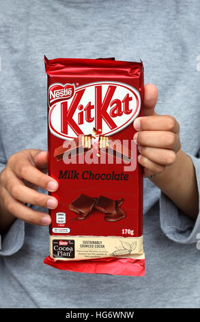 Child with a red packet isolated on green background. Little beauty ...