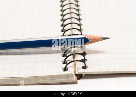 Pencil on the pages of an open notebook Stock Photo - Alamy