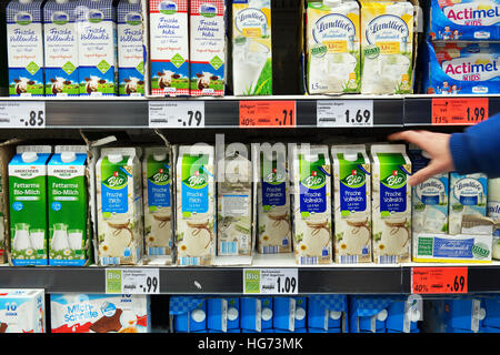 Customer takes bio milk packing in Supermarket Stock Photo - Alamy