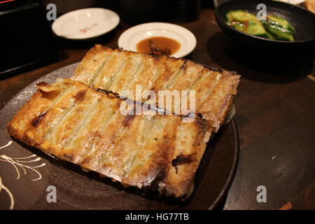 Crispy golden fried gyoza dumplings served on dark plate. Appetizing ...
