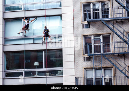 Bosun's chair man cleaning windows on tall buildings California Street ...