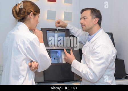 young techinicians checking eyeglass quality Stock Photo - Alamy