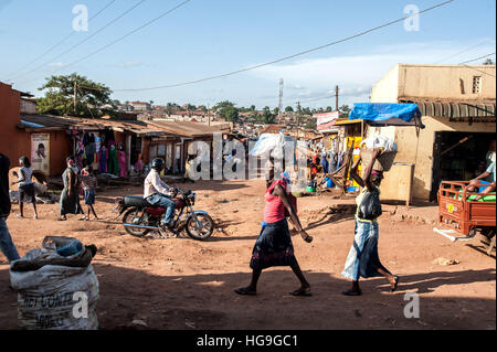 Residents walk through the streets of Katwe slum, Uganda Stock Photo ...