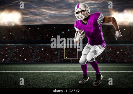 Football Player with a pink uniform Running on a pink background Stock ...