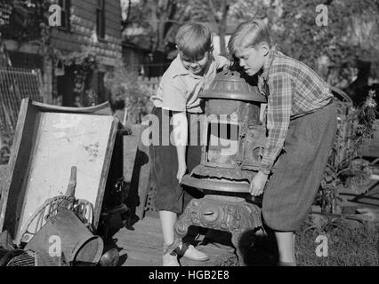 Young children collecting scrap for donation to their war industries ...