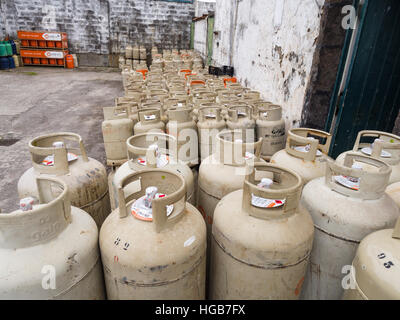 Butane Tanks in Storage. A large number of Butane gas tanks in a rough ...