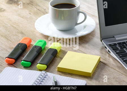 Different sticky notes, notebook, markers, pens and cup of coffee on ...
