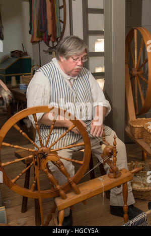 Colonial Williamsburg craftsman at spinning wheel Stock Photo - Alamy