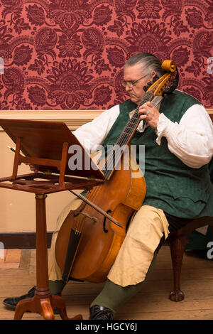 Colonial Williamsburg interpreter string instrument Stock Photo - Alamy