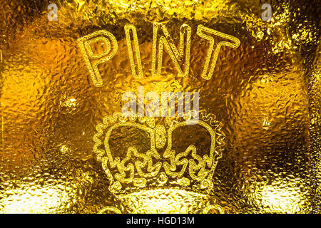 A dimpled pint glass etched with the Crown stamp rather than the ...