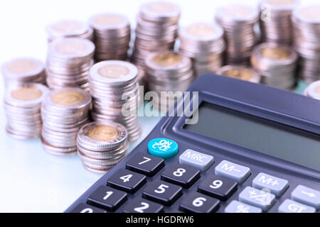 Couns and calculator on white background. Studio shot Stock Photo - Alamy