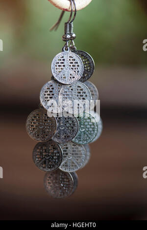 Metal earrings with Peace symbol Stock Photo - Alamy