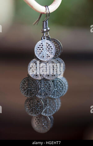 Metal earrings with Peace symbol Stock Photo - Alamy