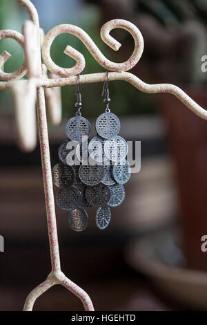 Metal earrings with Peace symbol Stock Photo - Alamy